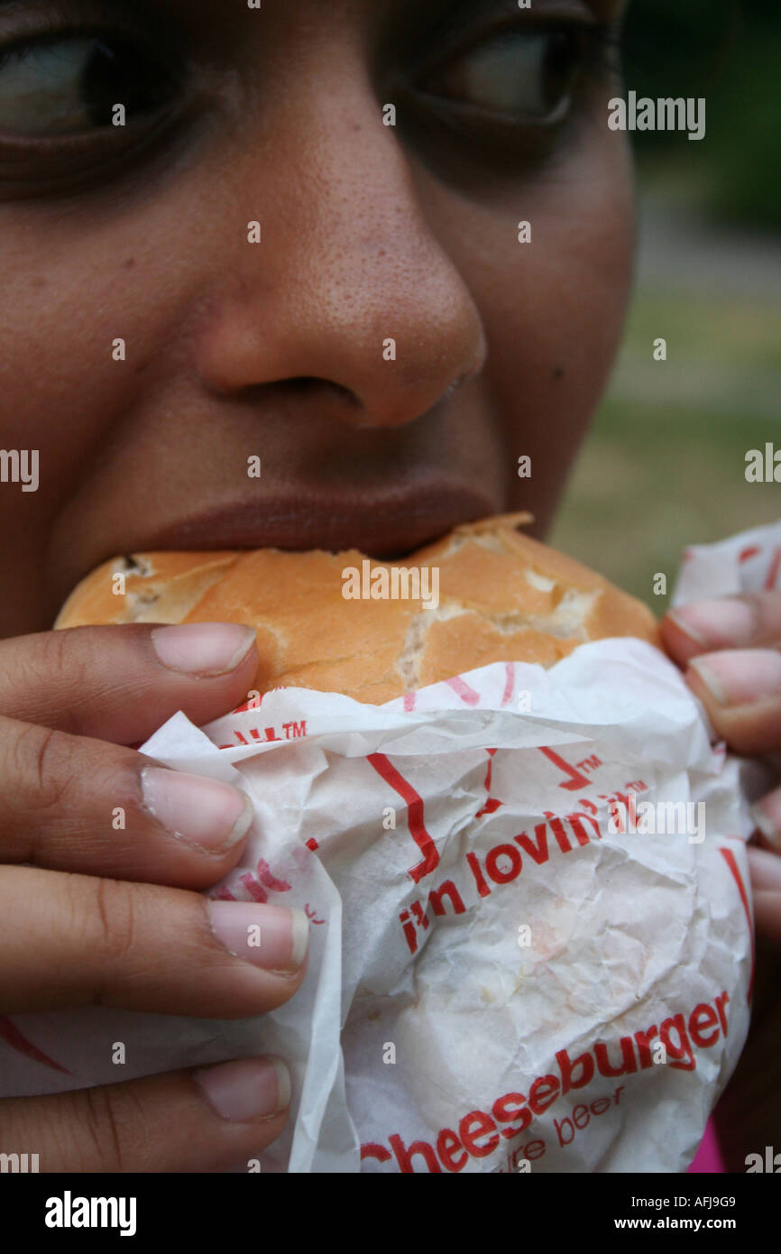 Women Eating a McDonalds Cheeseburger Stock Photo - Alamy
