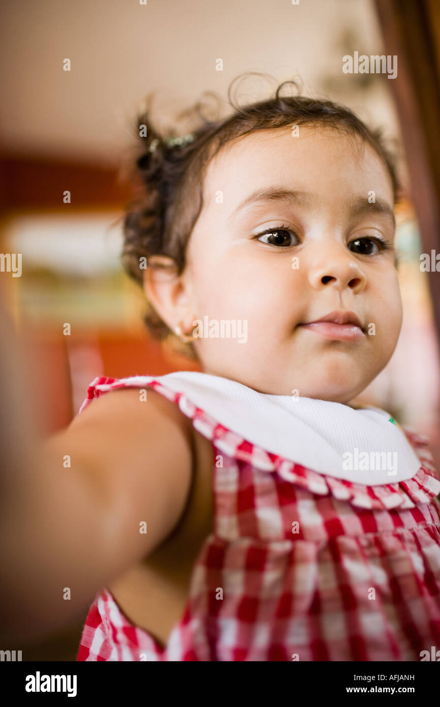 Close-up of a baby girl looking down Stock Photo - Alamy