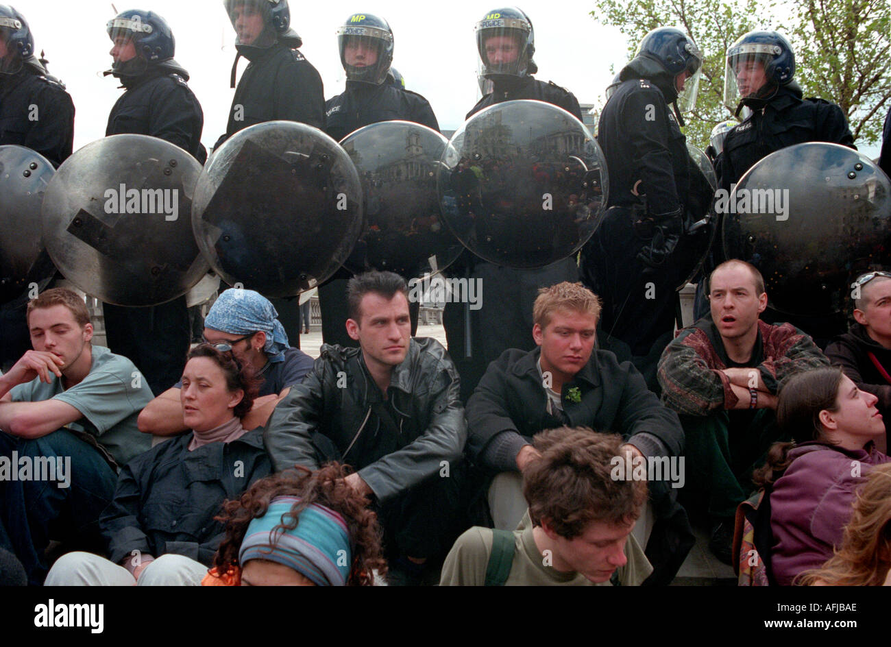 Woman demonstrator sits in front of police line Trafalgar Square ...