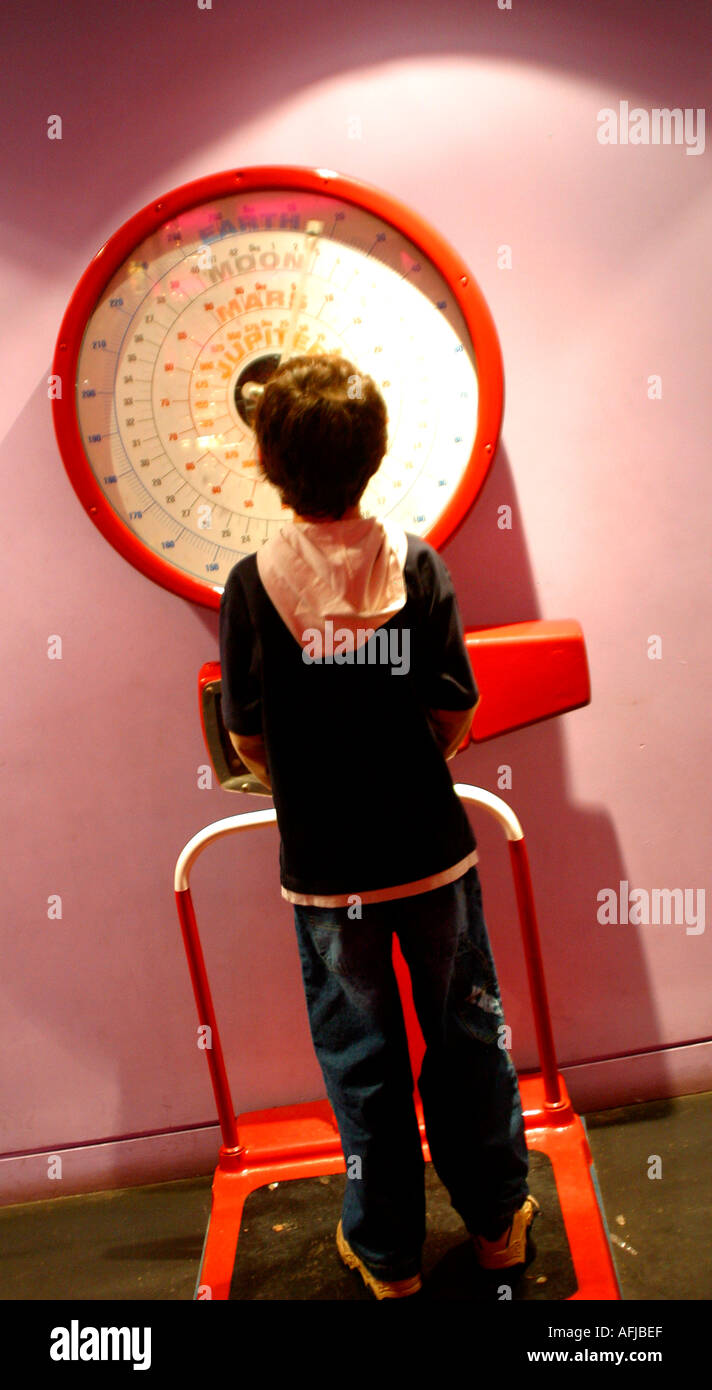 BOY ON WEIGHING SCALES Stock Photo - Alamy
