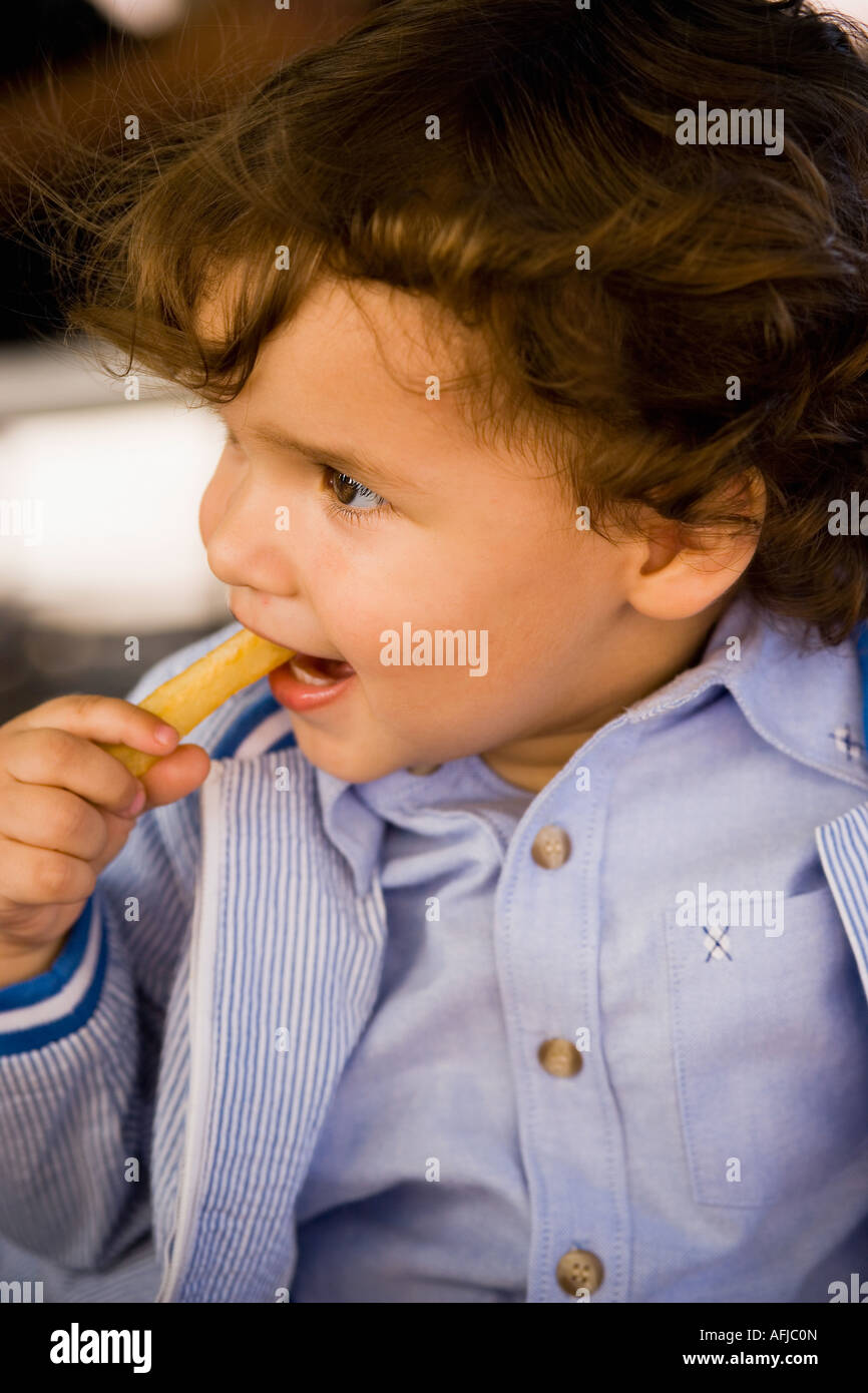 Close-up of a baby boy eating snacks Stock Photo - Alamy