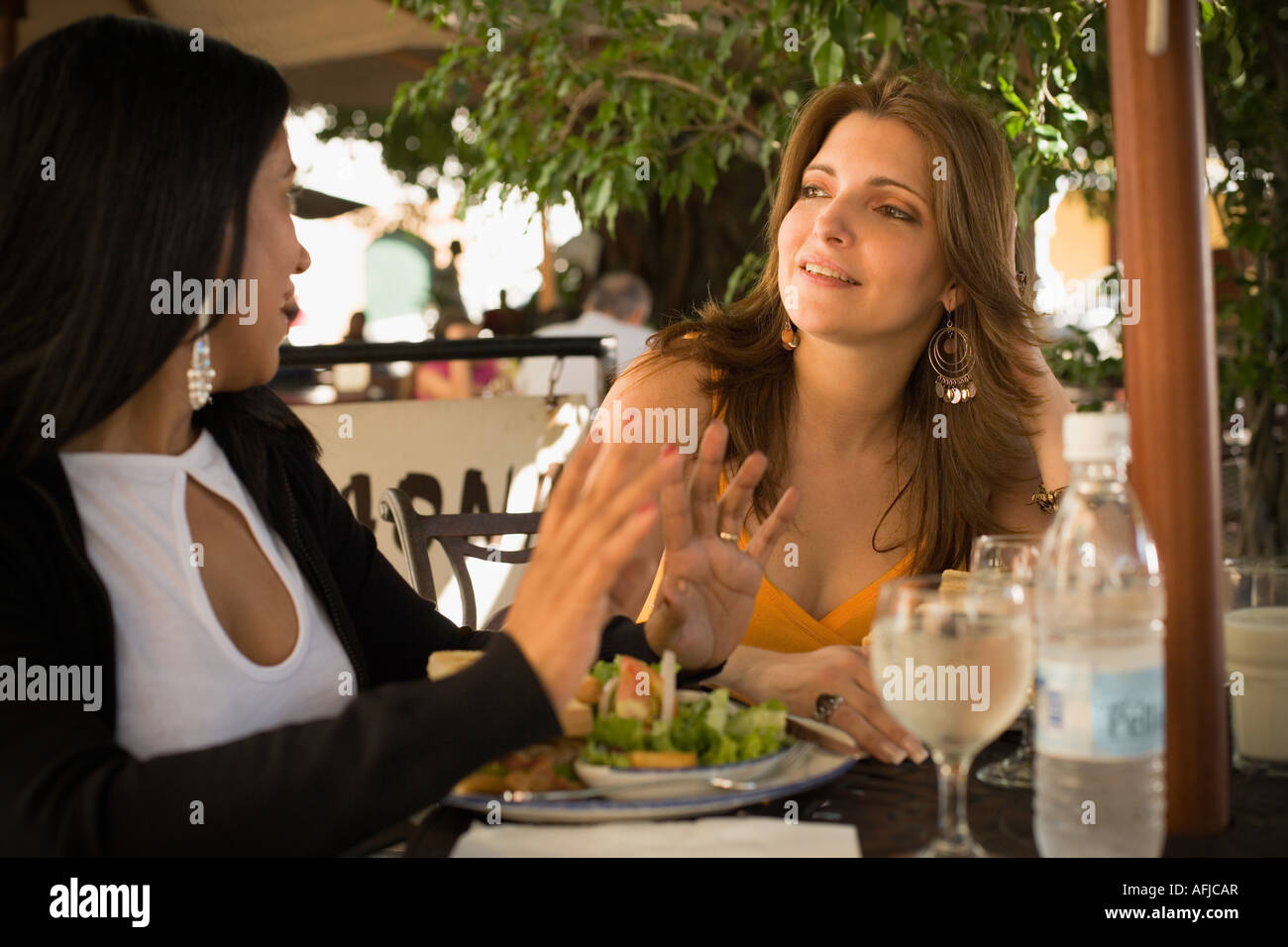 Two women sitting in a restaurant Stock Photo - Alamy