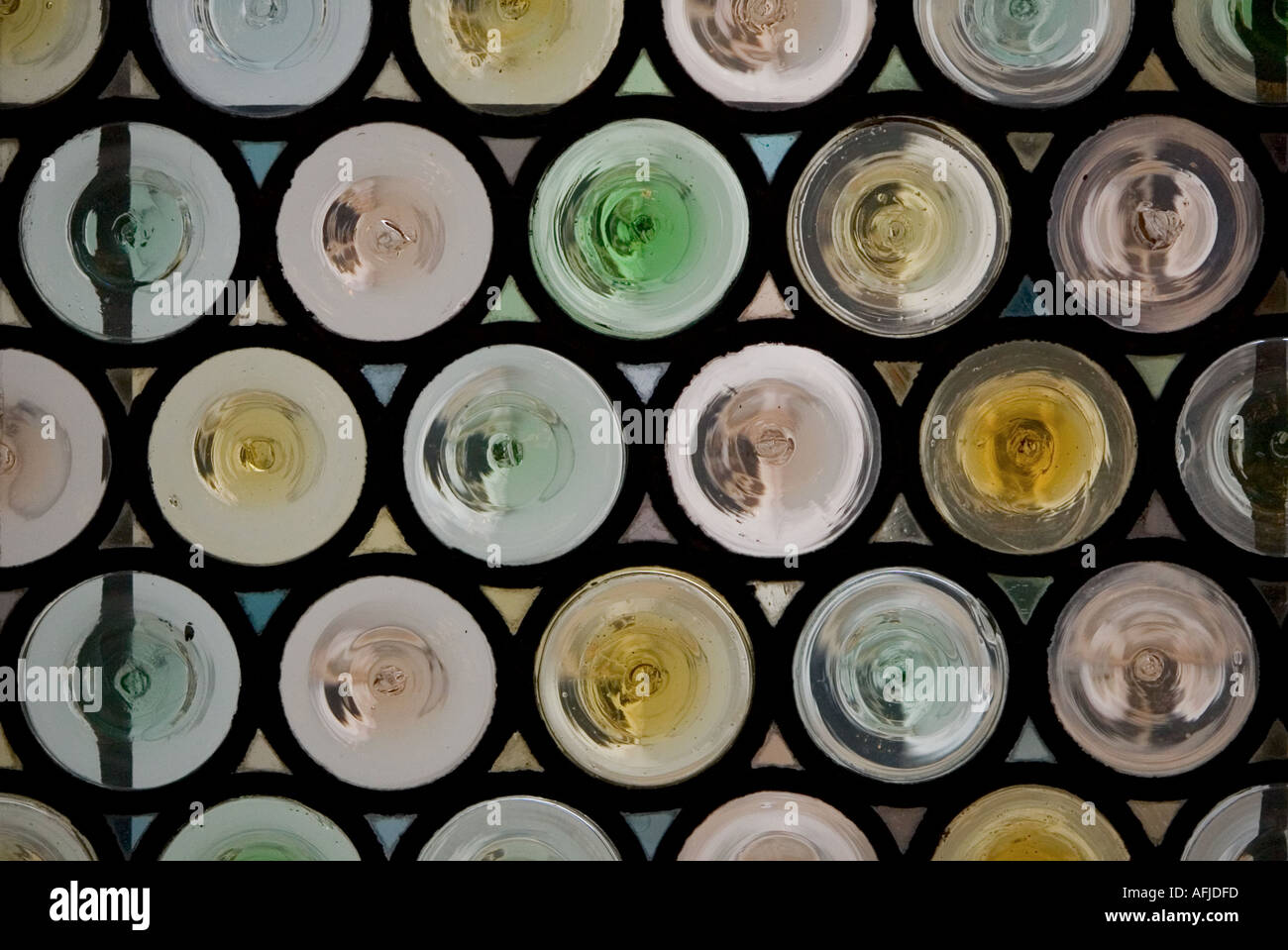 Rows of glass bottles forming a window Stock Photo - Alamy
