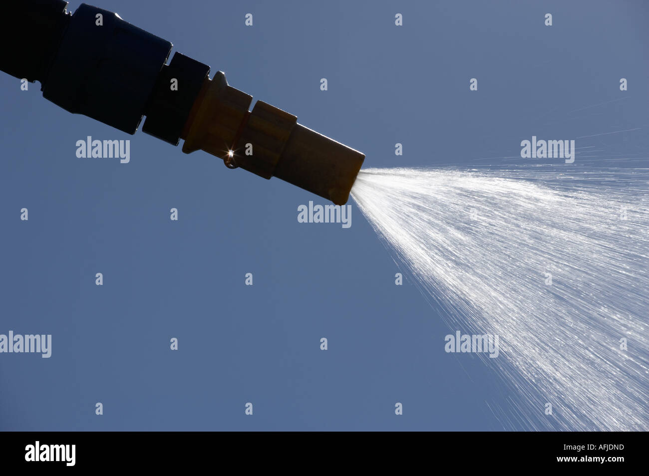 JET OF WATER SPRAYING FROM GARDEN HOSE PIPE IN SUMMER SUN Stock Photo ...