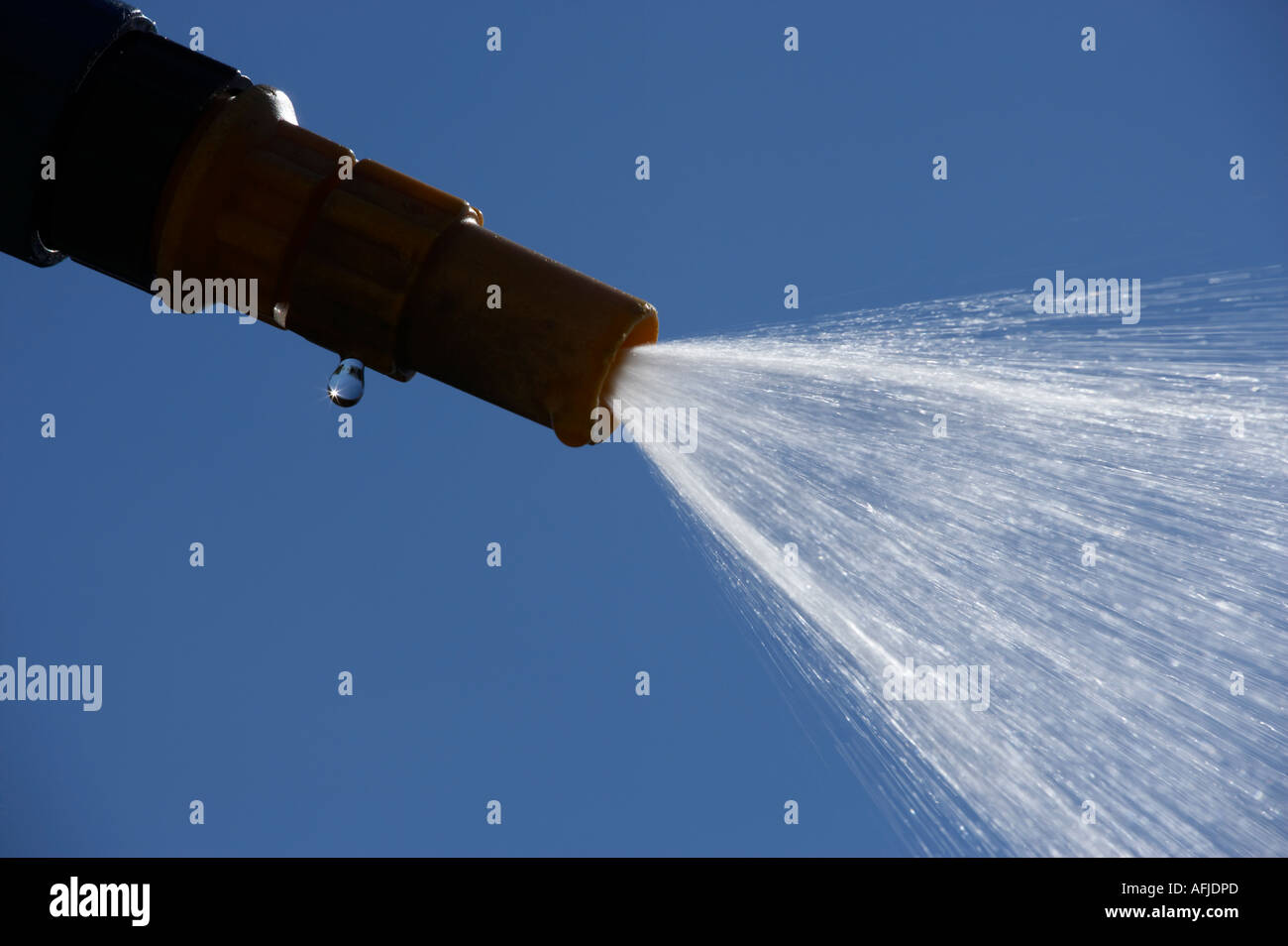 JET OF WATER SPRAYING FROM GARDEN HOSE PIPE IN SUMMER SUN Stock Photo ...