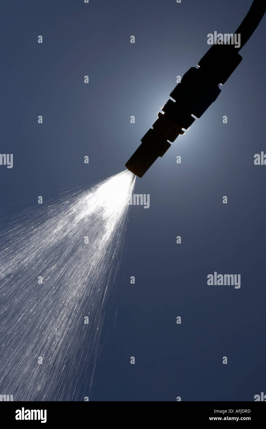 JET OF WATER SPRAYING FROM GARDEN HOSE PIPE IN SUMMER SUN Stock Photo ...