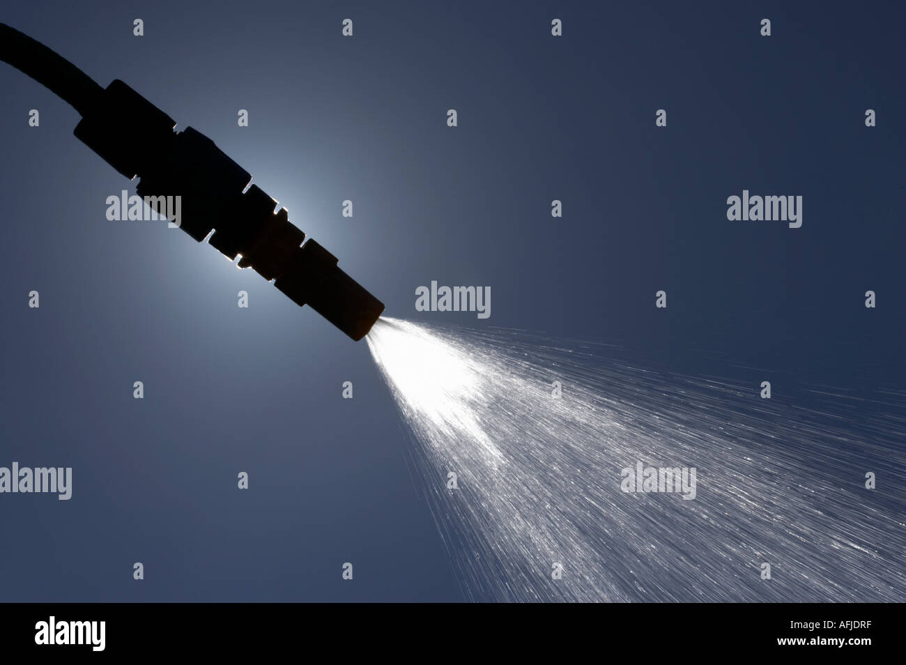 JET OF WATER SPRAYING FROM GARDEN HOSE PIPE IN SUMMER SUN Stock Photo ...