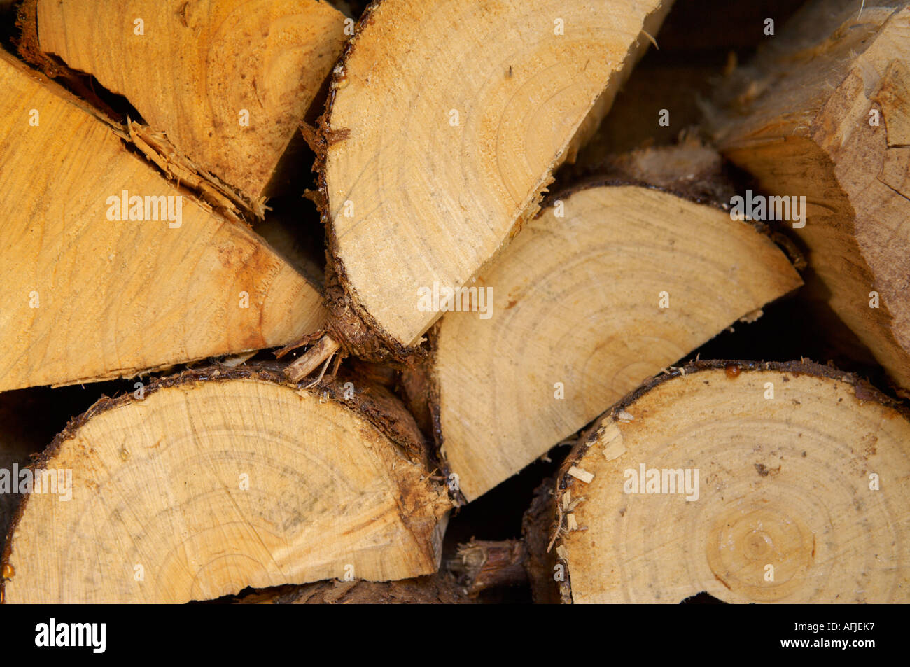 Logs stacked ready for a fire Stock Photo - Alamy