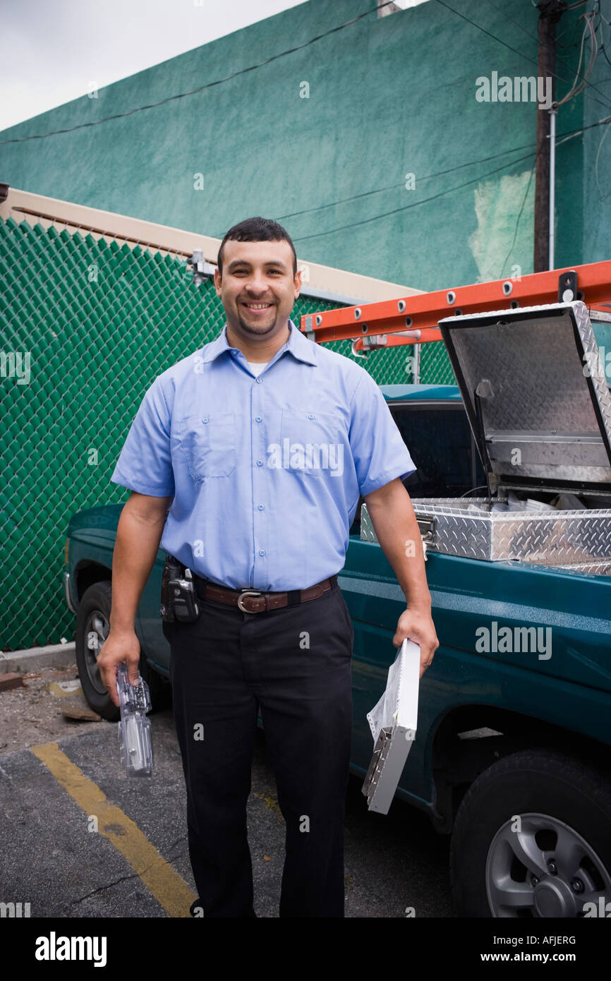 Cable man standing near his truck Stock Photo - Alamy