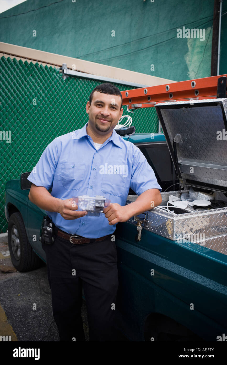 Cable man standing near his truck Stock Photo - Alamy