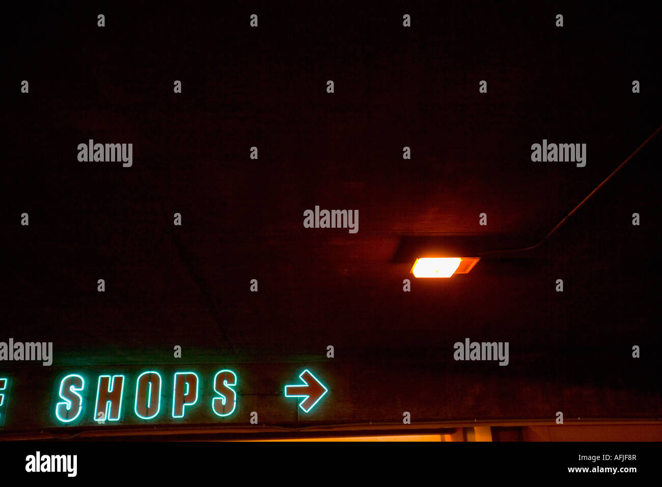 Neon Shops sign lit in shopping mall parking garage Stock Photo - Alamy