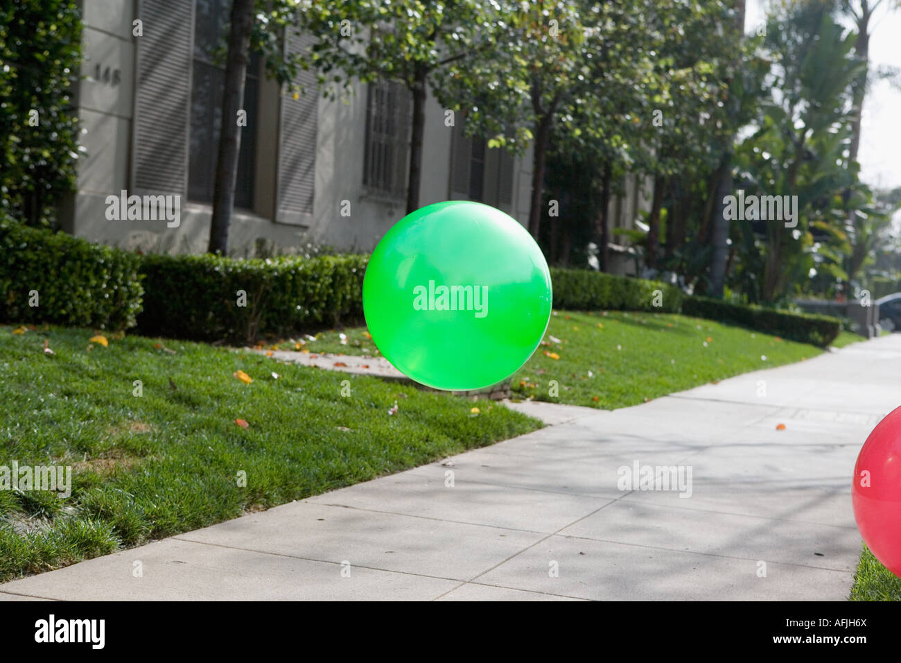 Two balloons flying over a walkway Stock Photo - Alamy