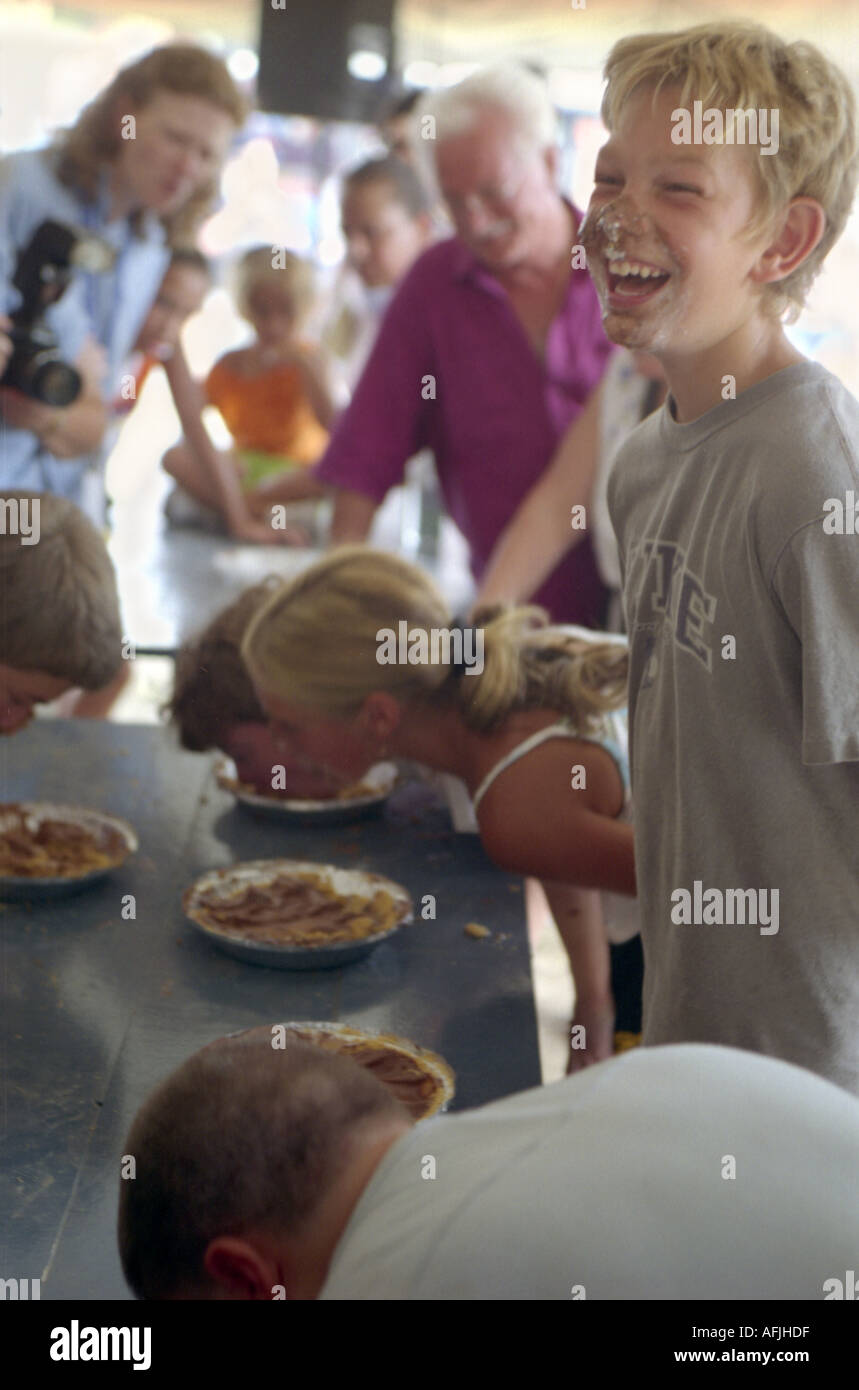 Laughing child in pie eating contest at a state agricultural fair Stock ...