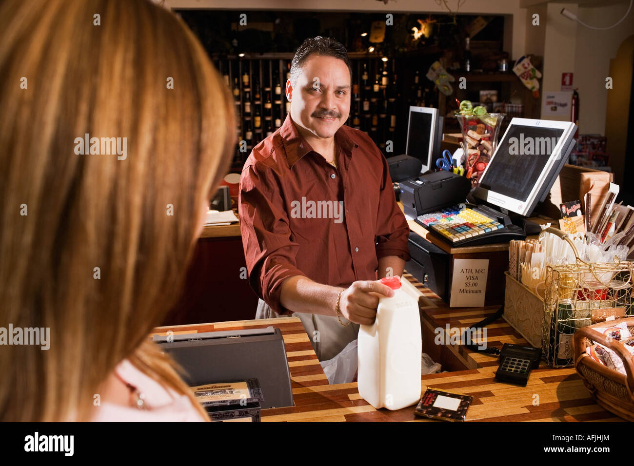 Business owner checking customers groceries Stock Photo - Alamy