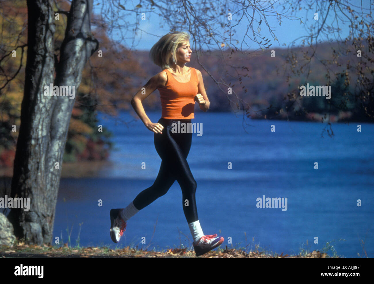Woman jogging on lake hi-res stock photography and images - Alamy