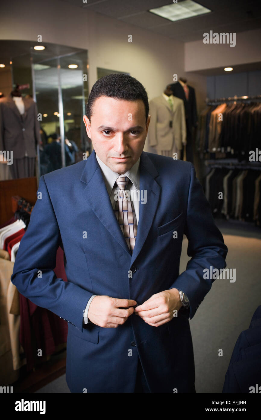 Sales associate in menswear store in mall Stock Photo - Alamy
