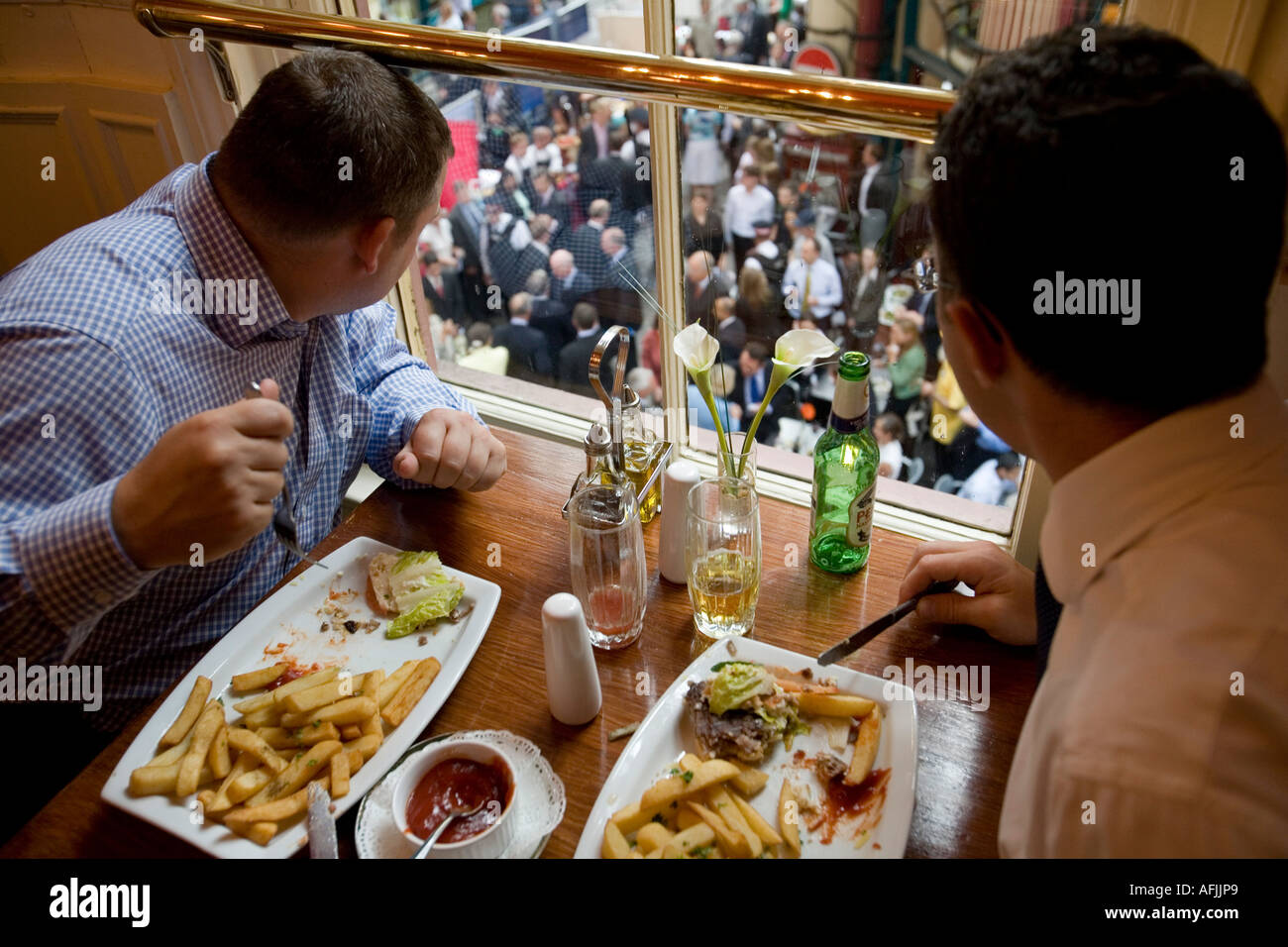 People at restaurant table looking out the window Stock Photo - Alamy