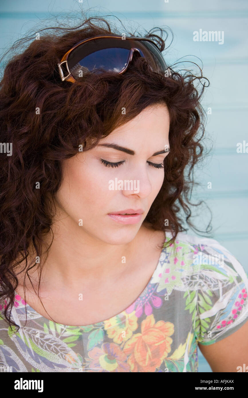 Brunette woman with sunglasses on head Stock Photo - Alamy