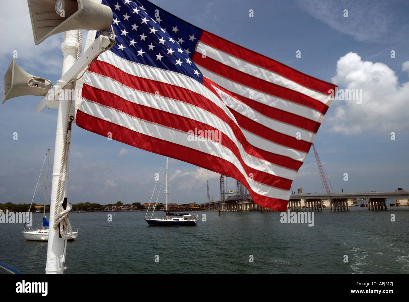 American Flag flying from mast of sightseeing boat Victory flies over ...
