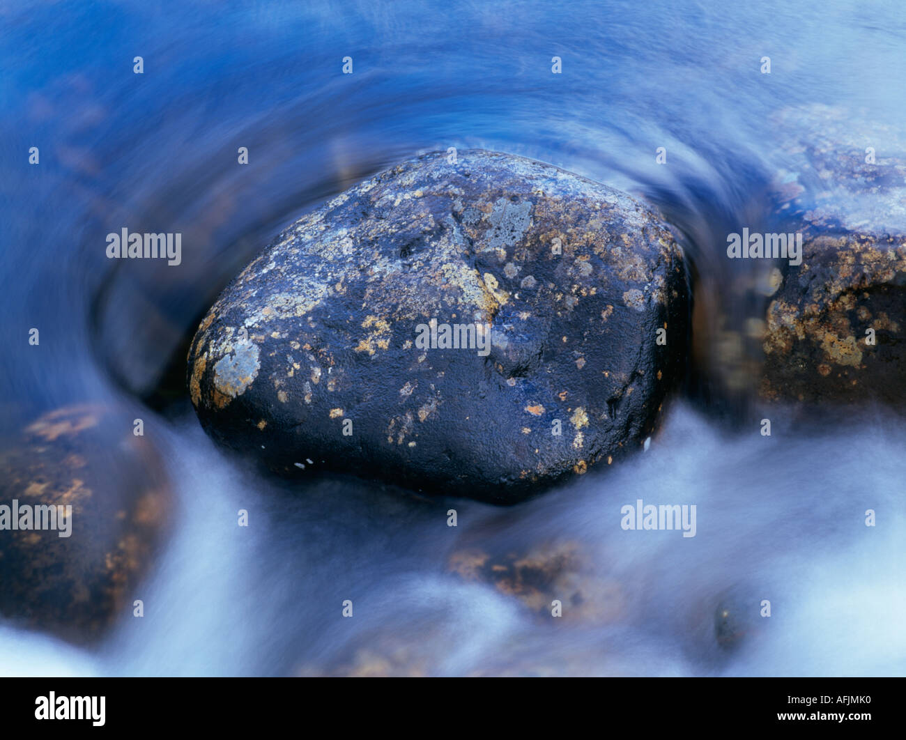 Rock and Blue Water Stock Photo - Alamy