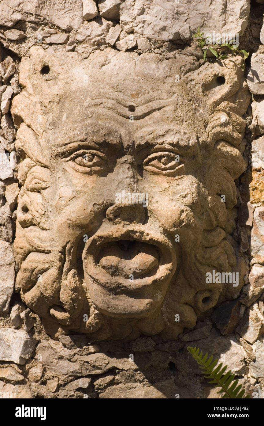 Color vertical image showing detail of a stone face spout on public ...