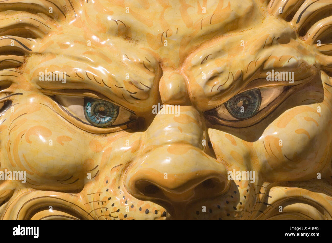 Color horizontal detail image of the eyes of a ceramic sun feline ...