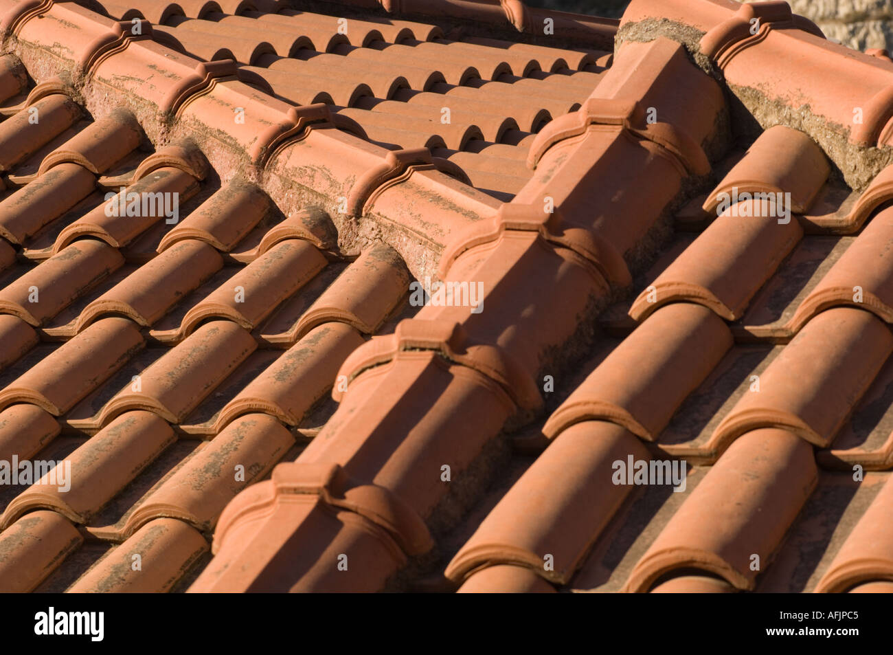color horizontal image of overlapping terra cotta roof tiles close up ...