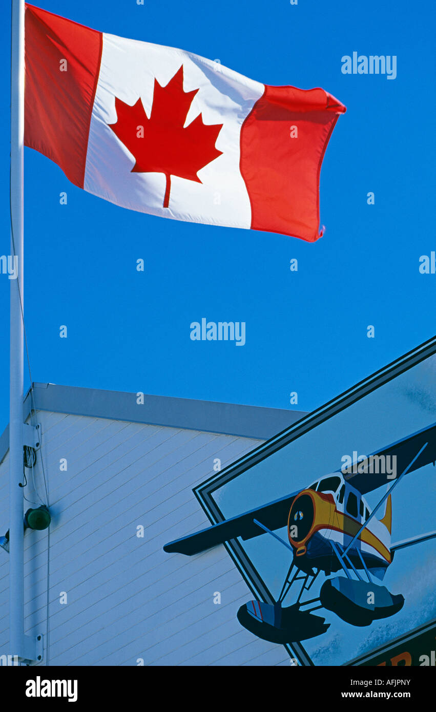 Canadian flag flying above a sign advertising floatplane trips at ...