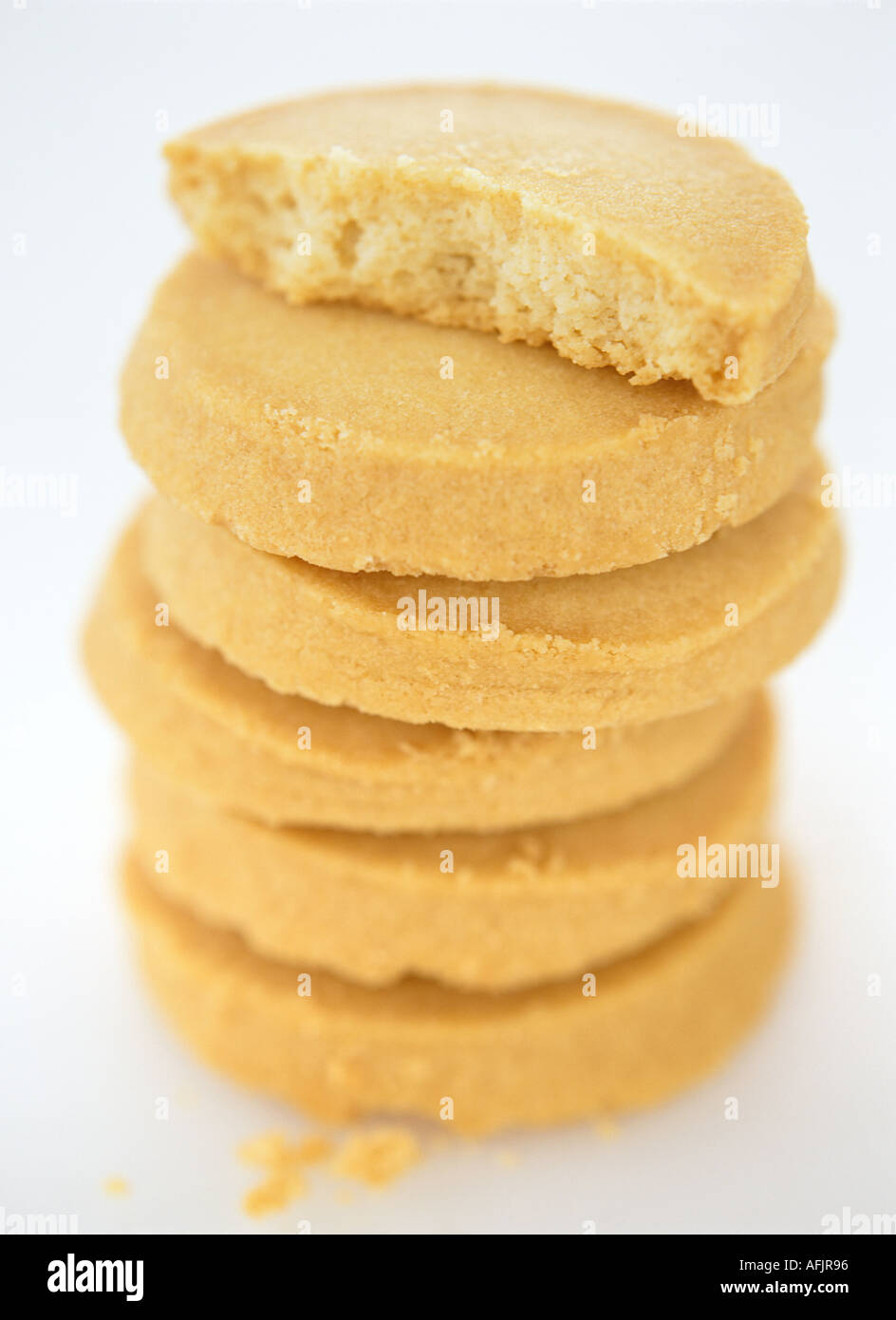 Stack of biscuits with one eaten on white background Stock Photo - Alamy