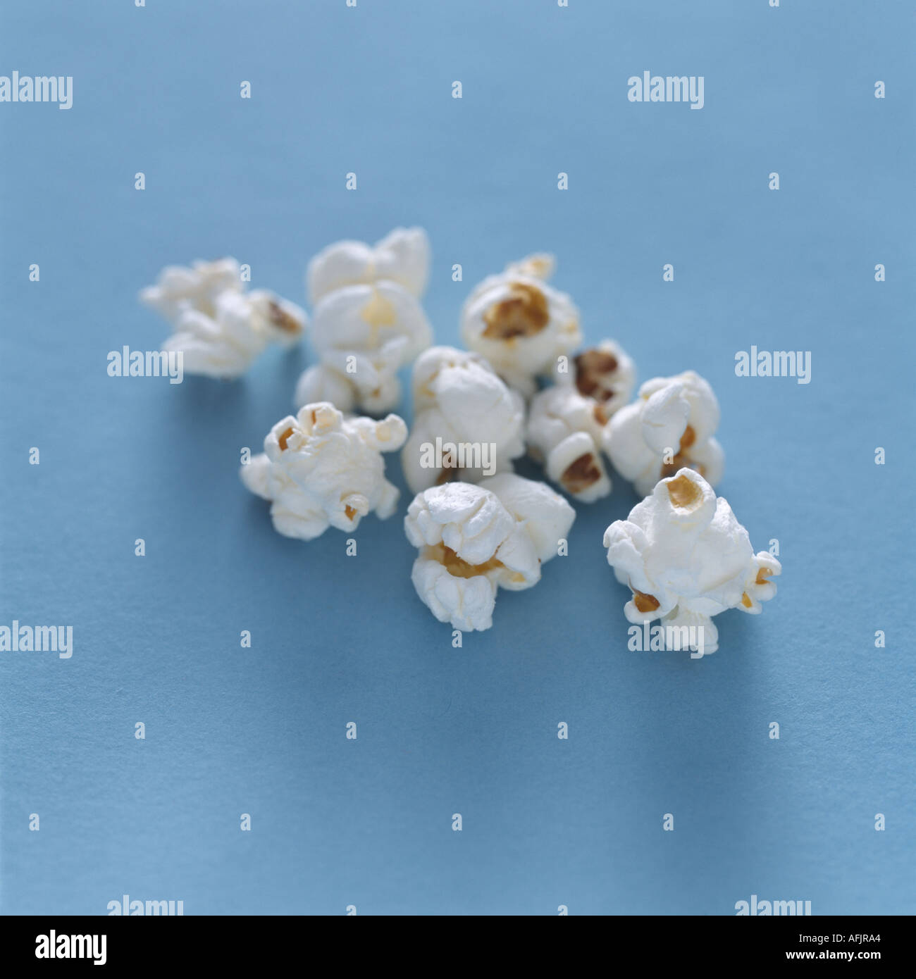 Popcorn on pale blue background Stock Photo - Alamy