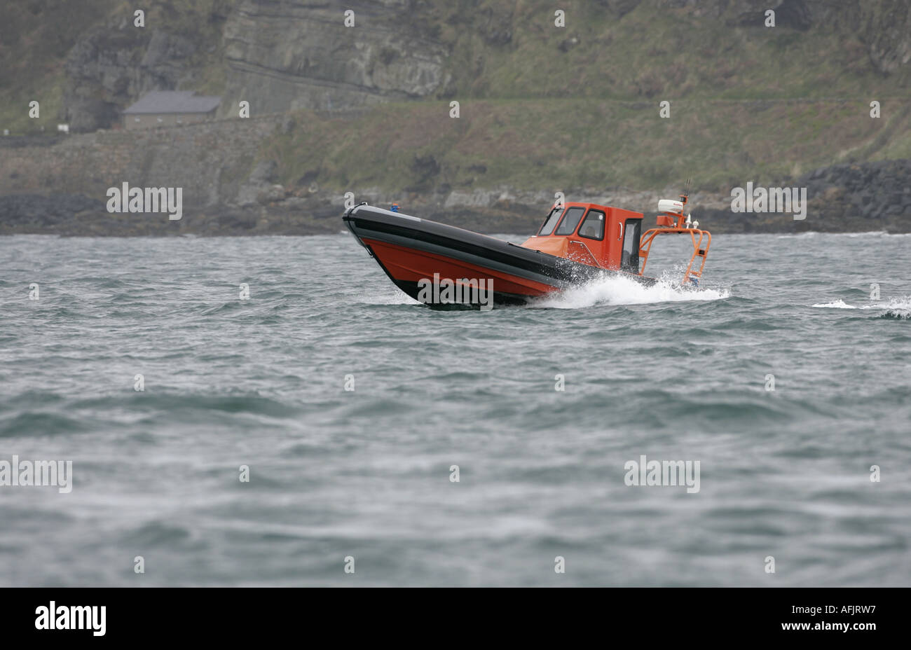 orange RIB Rigid hulled inflatable boat RHIB on sea trials at speed in ...