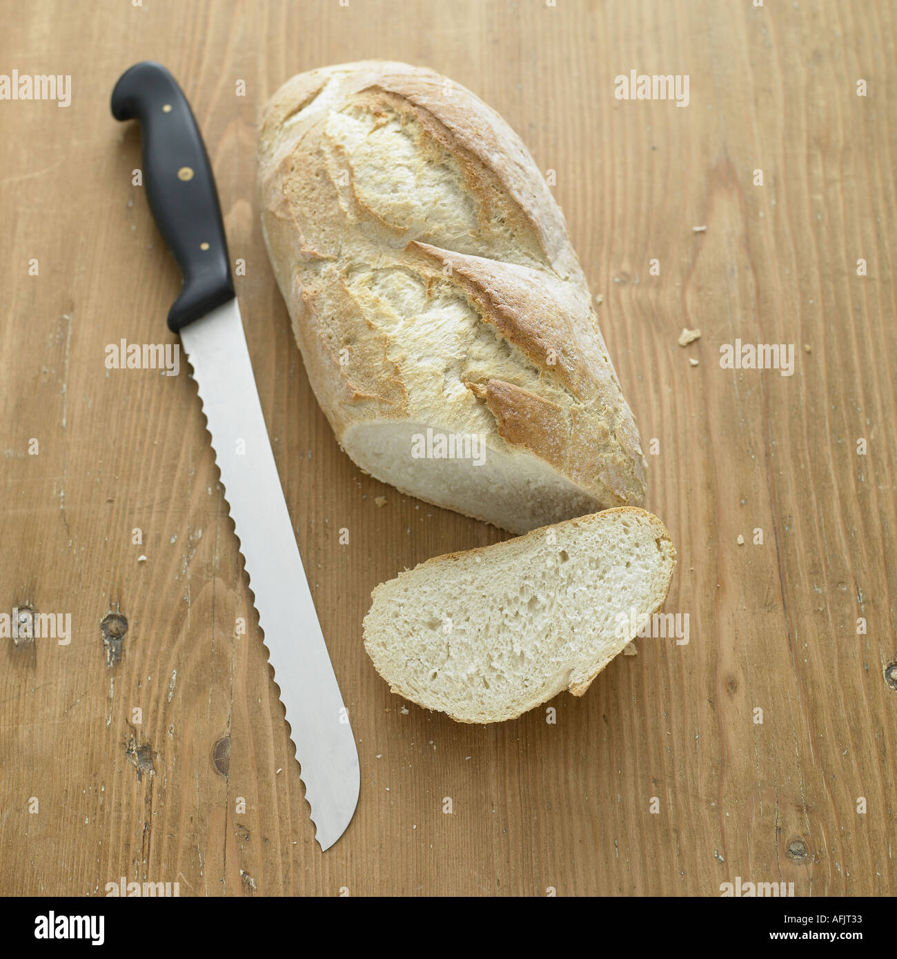 crusty white bread and knife Stock Photo - Alamy
