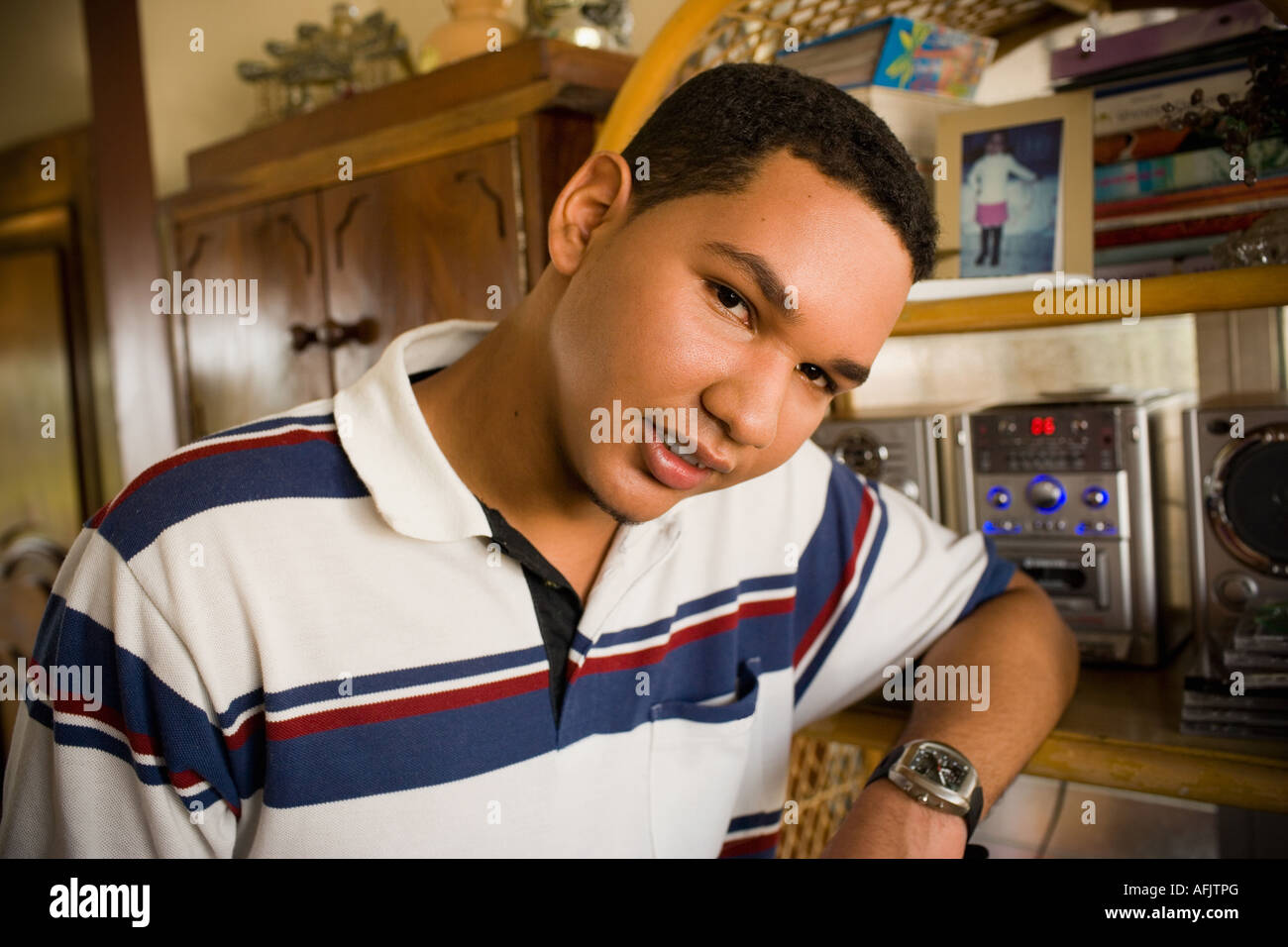 Young man leaning against a shelf Stock Photo - Alamy