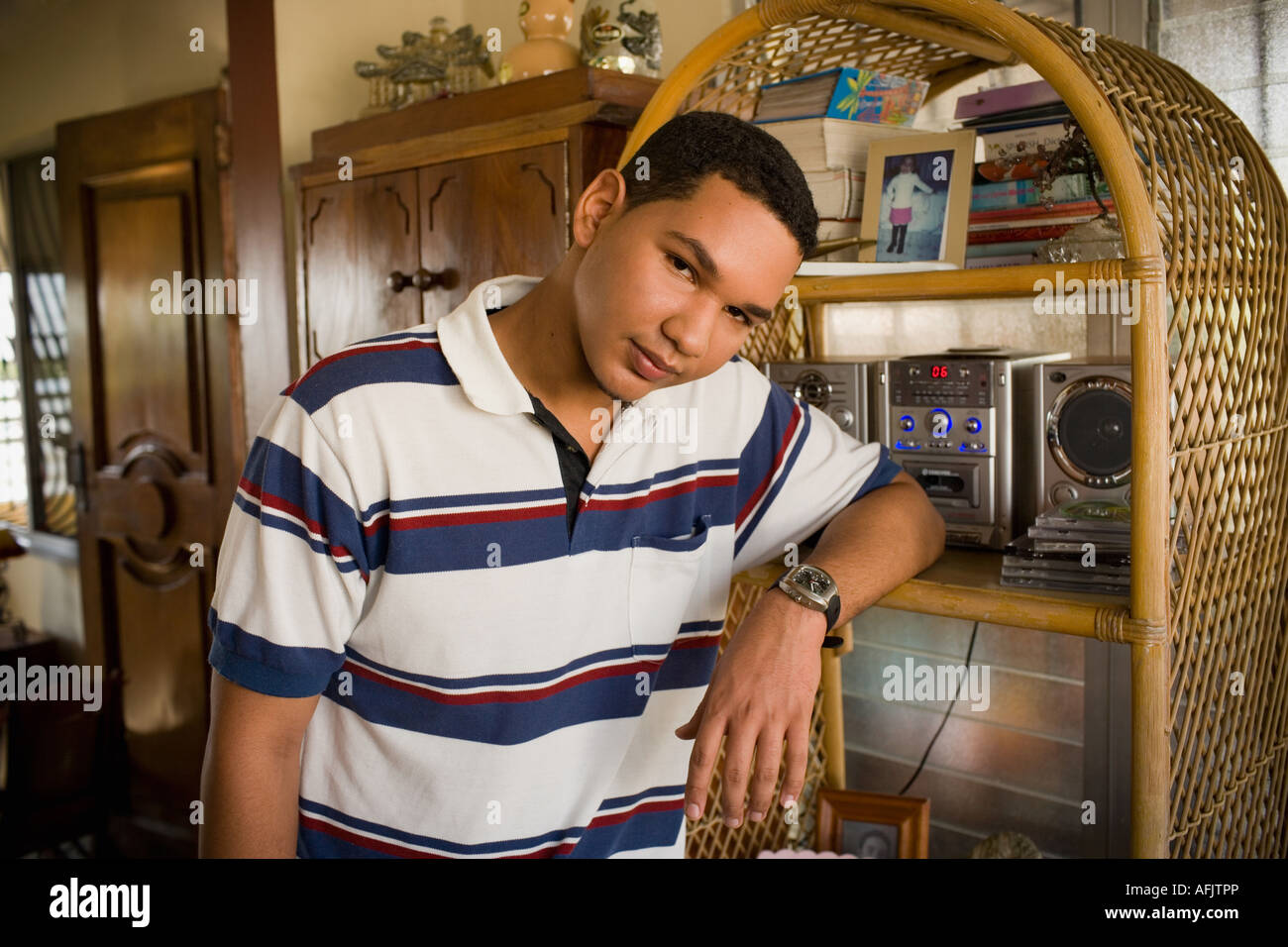 Young man leaning against a shelf Stock Photo - Alamy