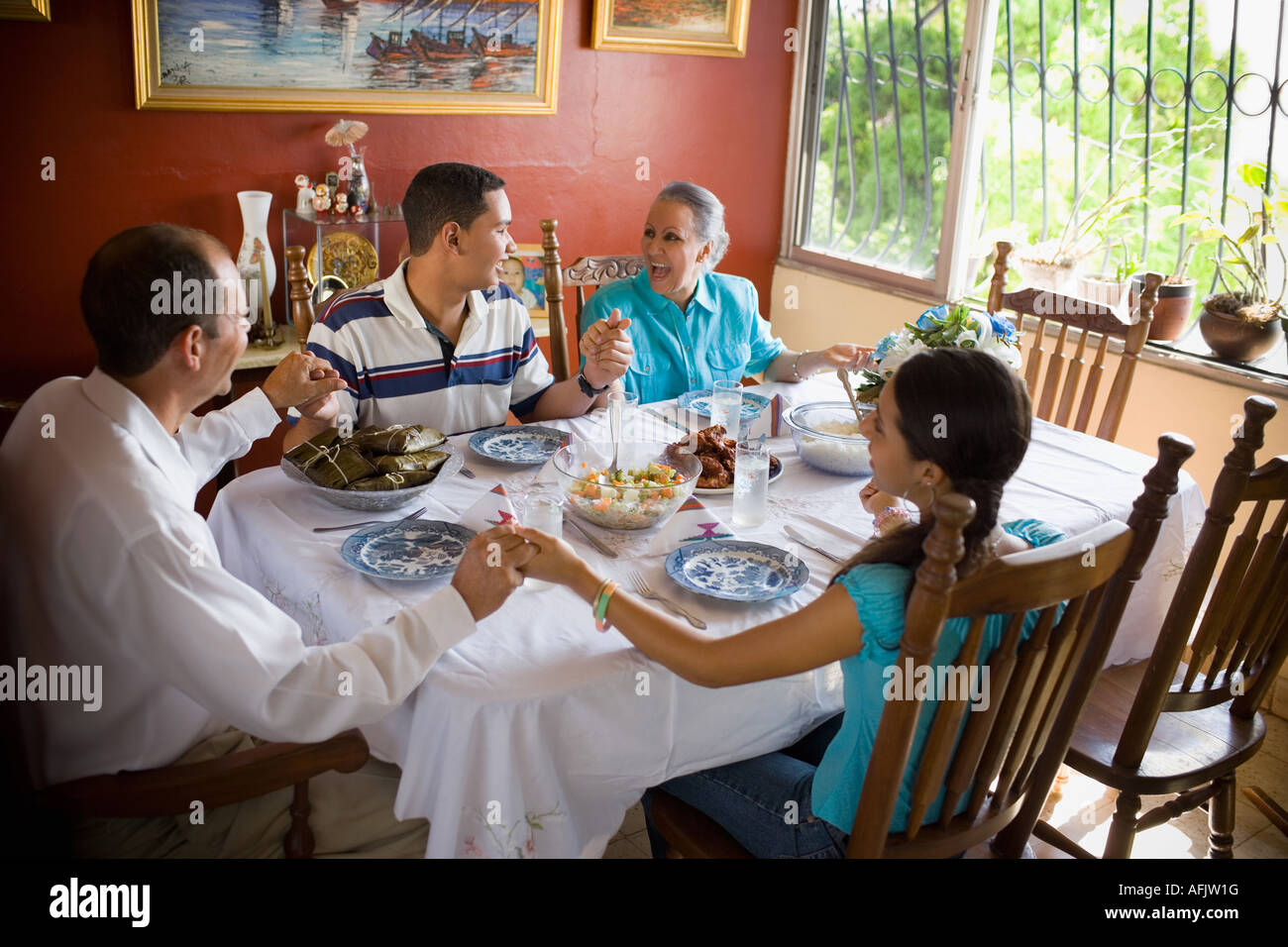 Family at a dining table Stock Photo - Alamy