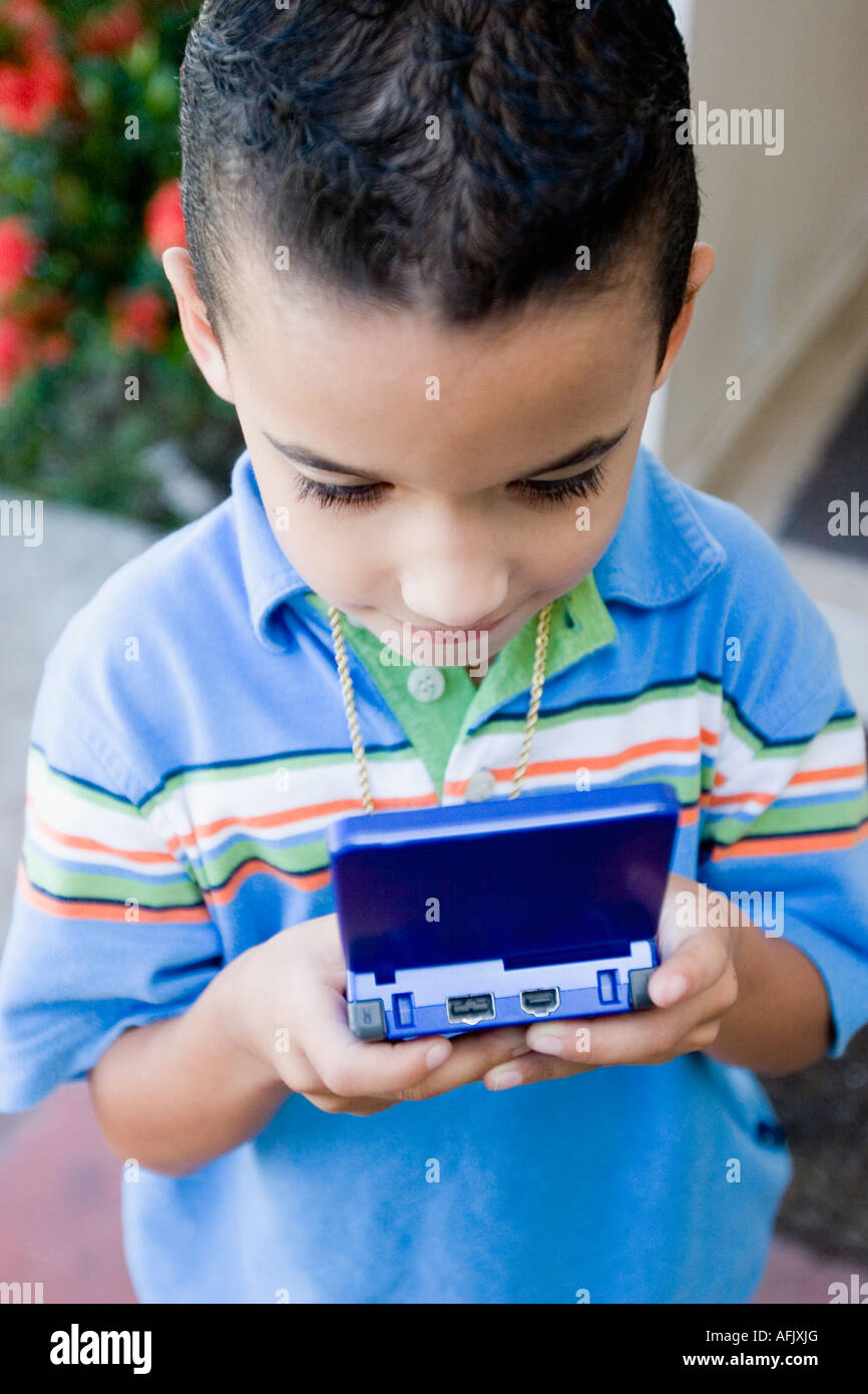 Close-up of a boy playing a handheld video game Stock Photo - Alamy