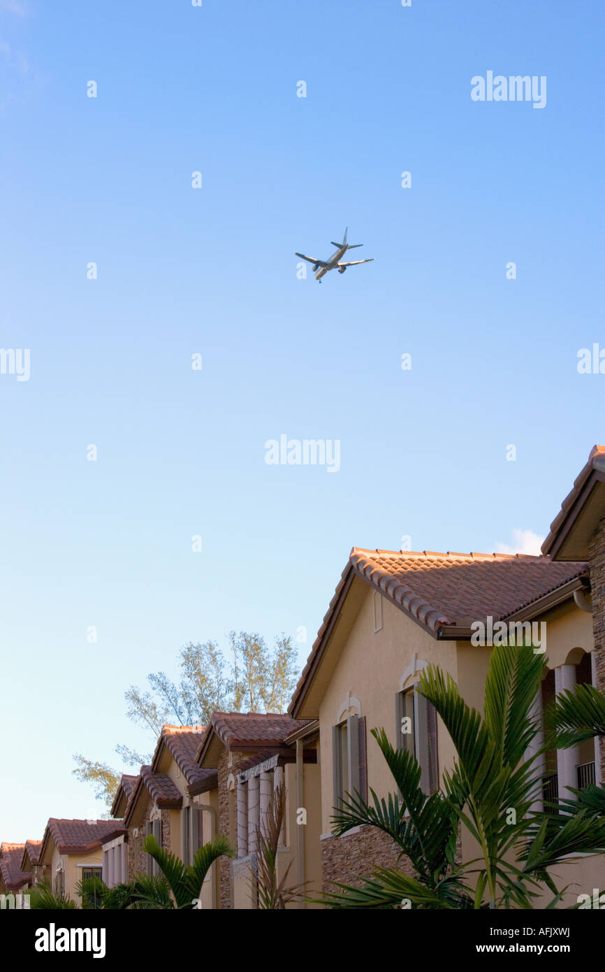 Airplane flying over neighborhood Stock Photo - Alamy