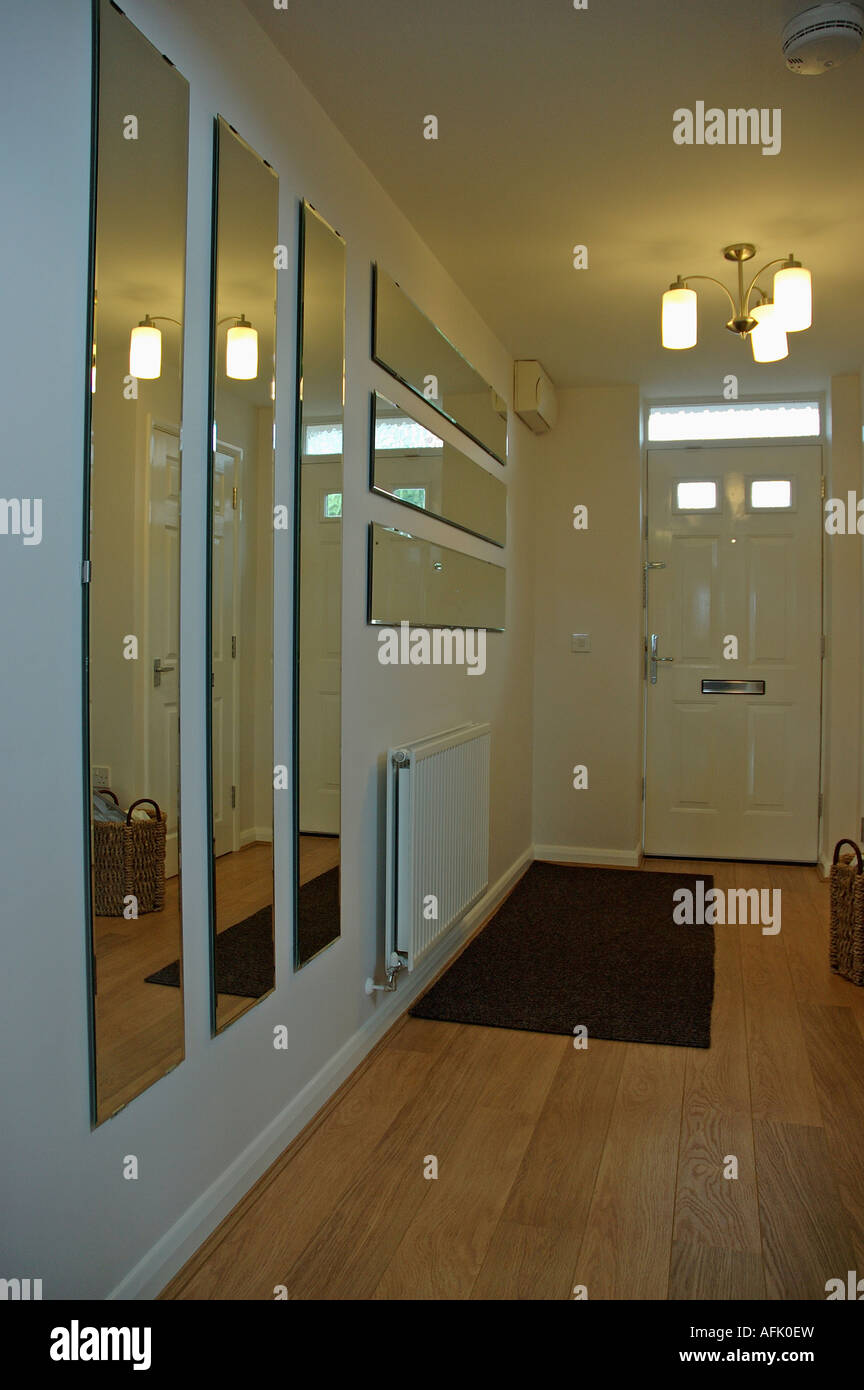 Collection of rectangular mirrors in modern white hall with wooden ...