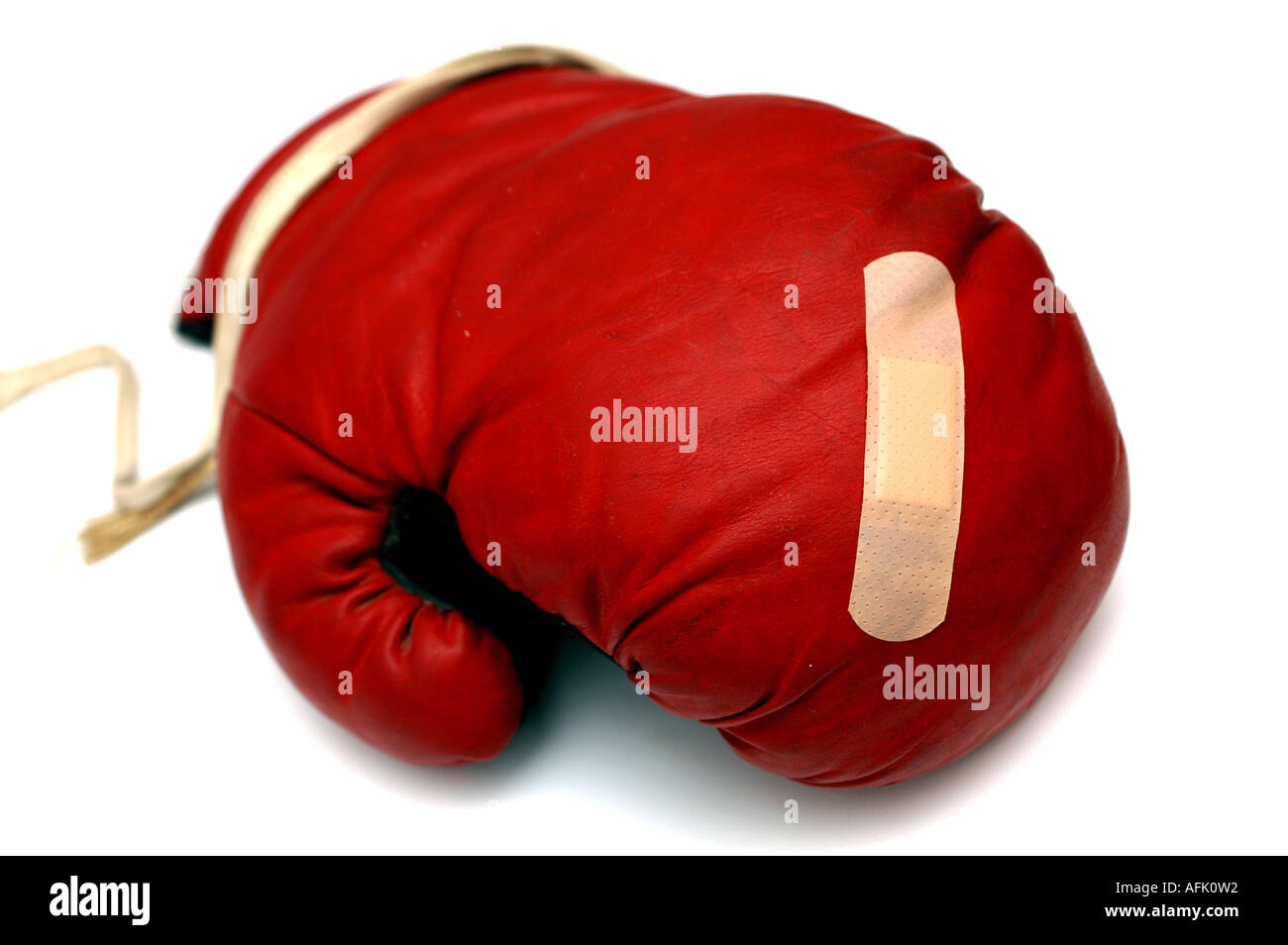 Red boxing glove with band aid on a white background Stock Photo - Alamy