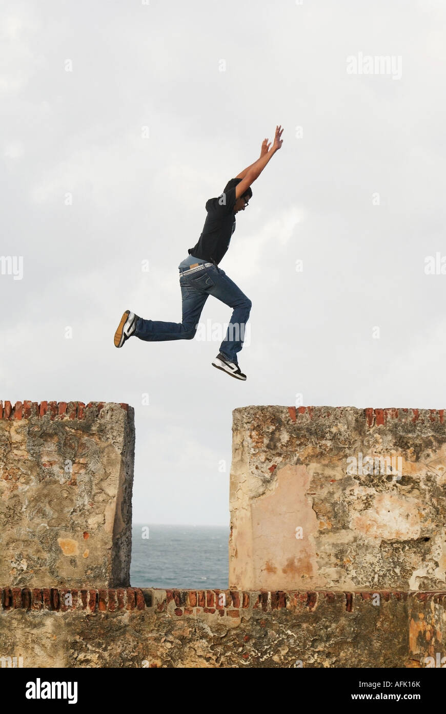 Man jumping over stone wall hi-res stock photography and images - Alamy