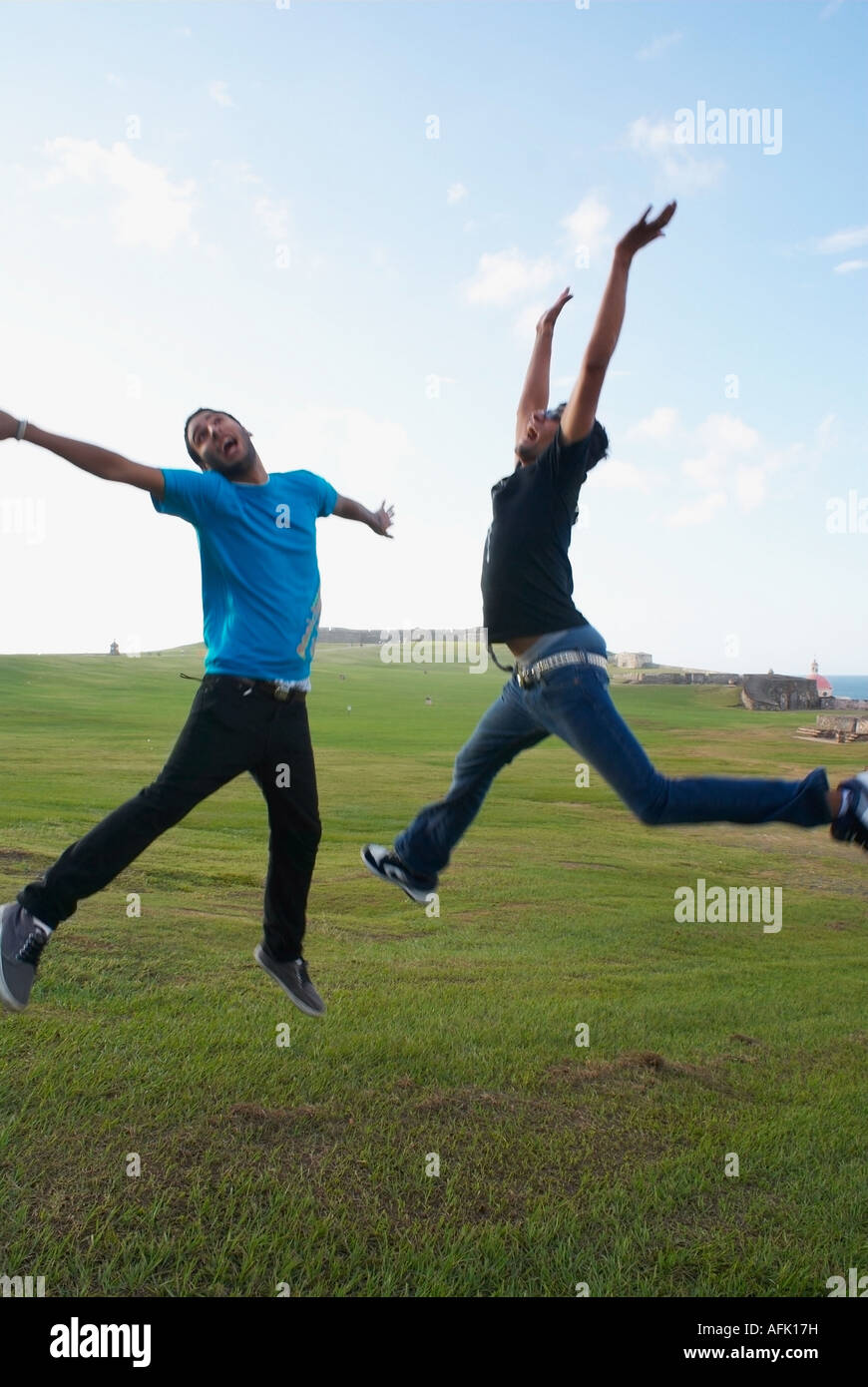 Young men jumping Stock Photo - Alamy