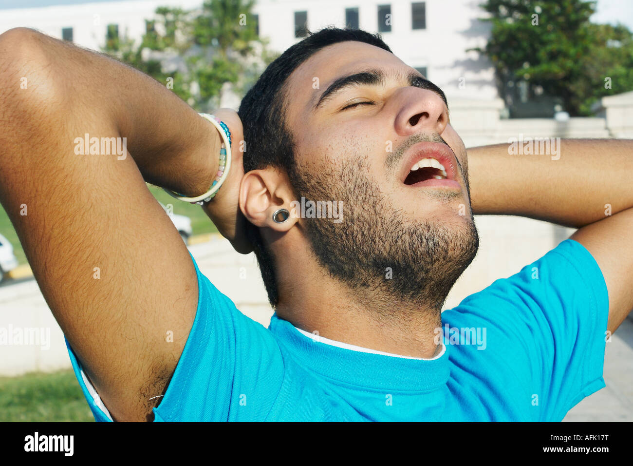 Young man yawning Stock Photo - Alamy