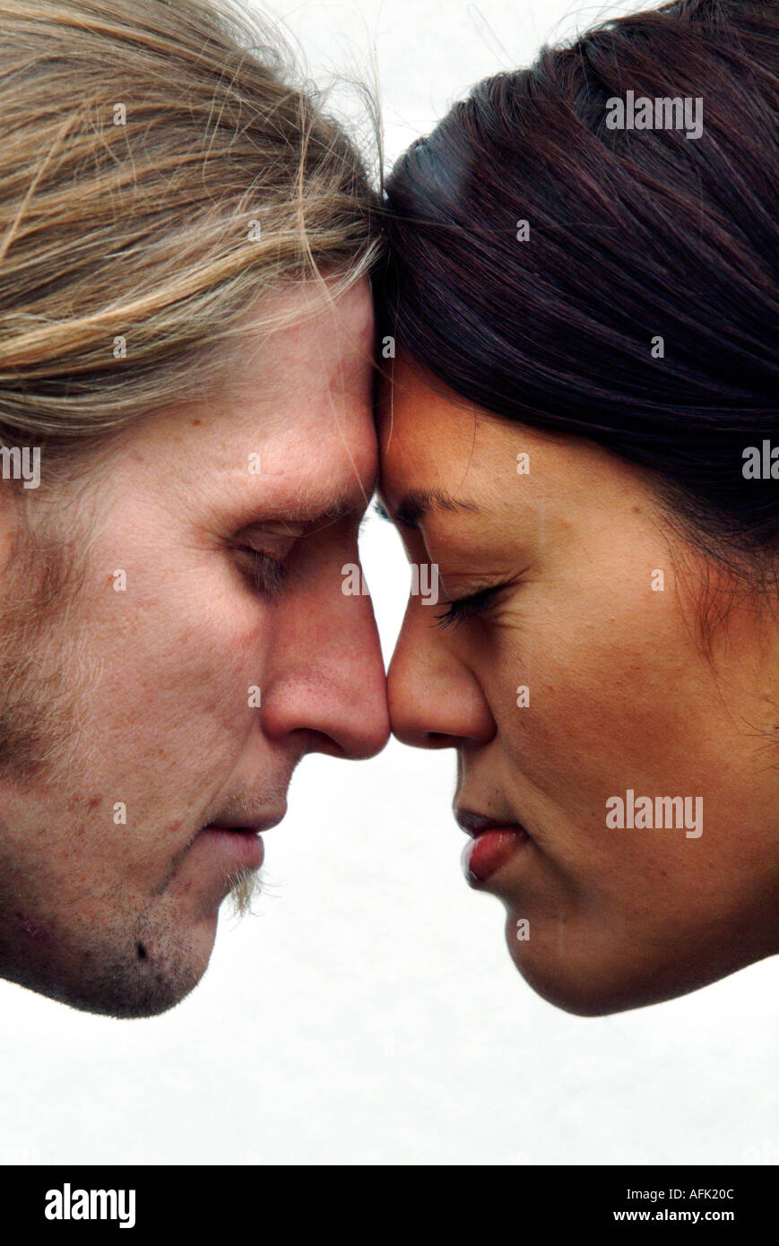 Hongi Maori greeting male and female in profile Stock Photo - Alamy
