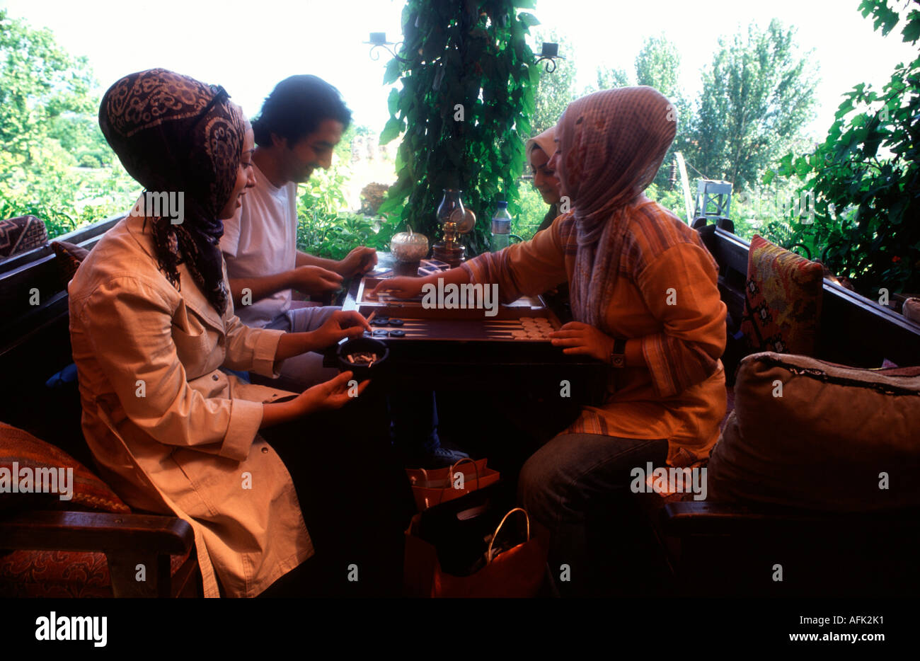 Young Turkish women in traditional dress play backgammon table game in ...