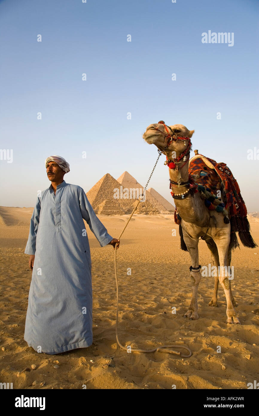 A camel driver stands in front of the pyramids at Giza, Egypt. (MR ...