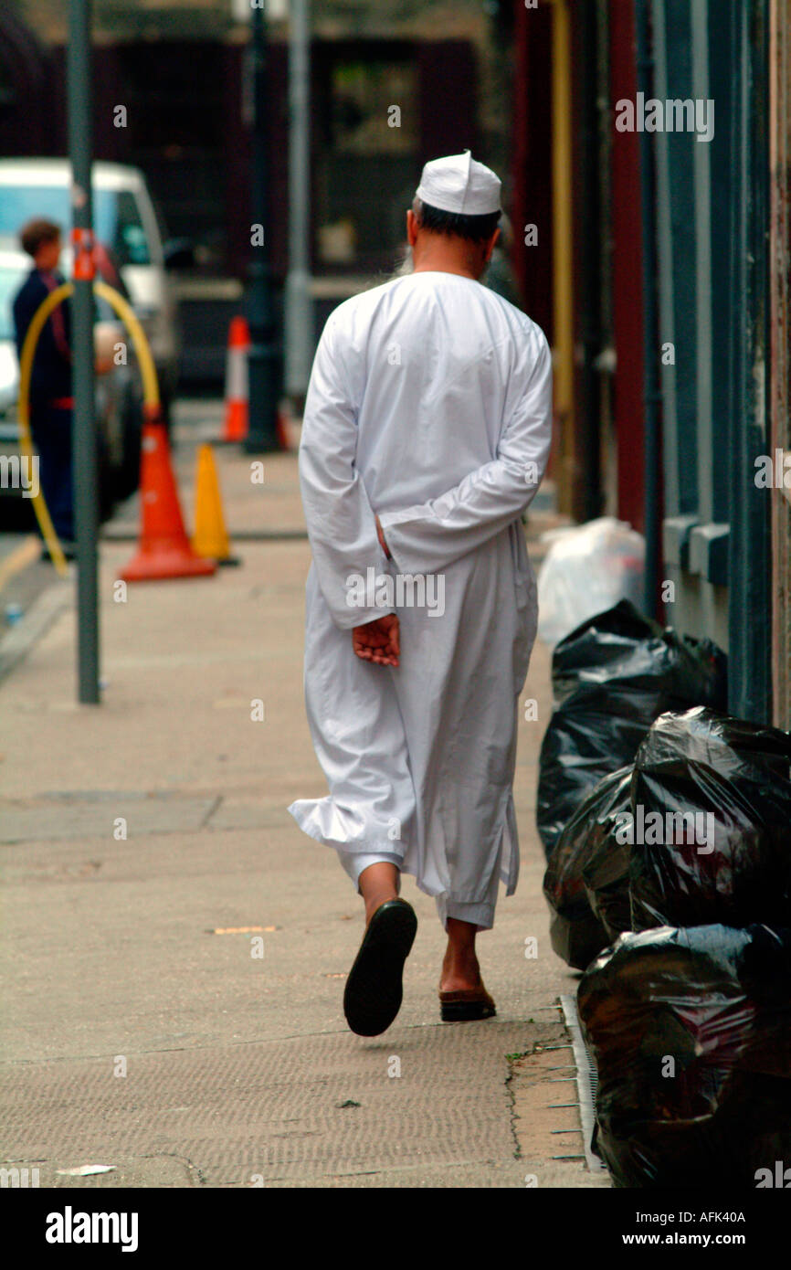 An Arab man in traditional dress walks down Brick Lane London United ...