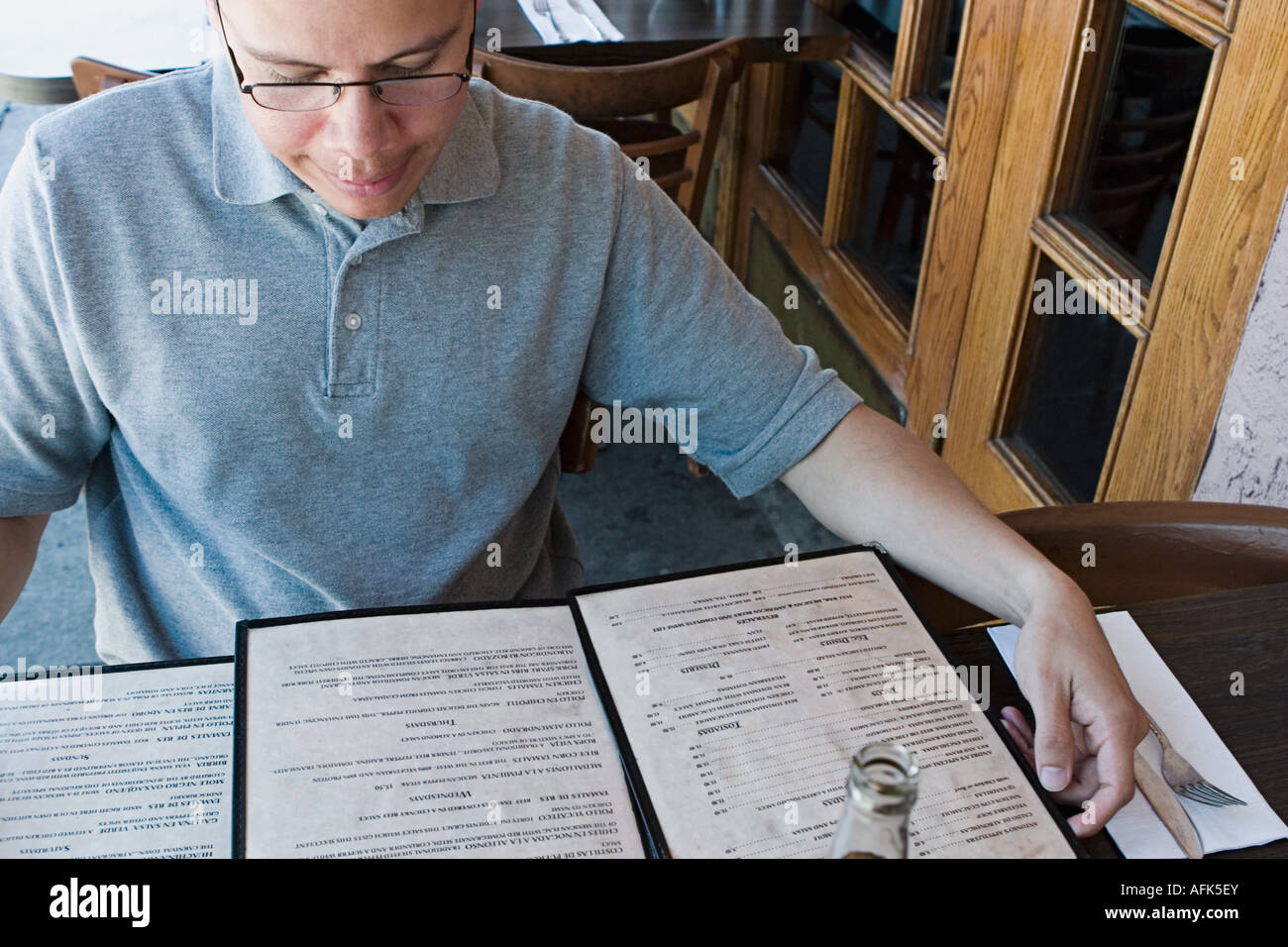 Man reading menu at outdoor restaurant Stock Photo - Alamy