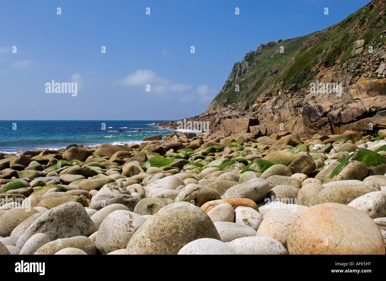Smooth boulders line the coast at Porth Nanven on the north coast of ...