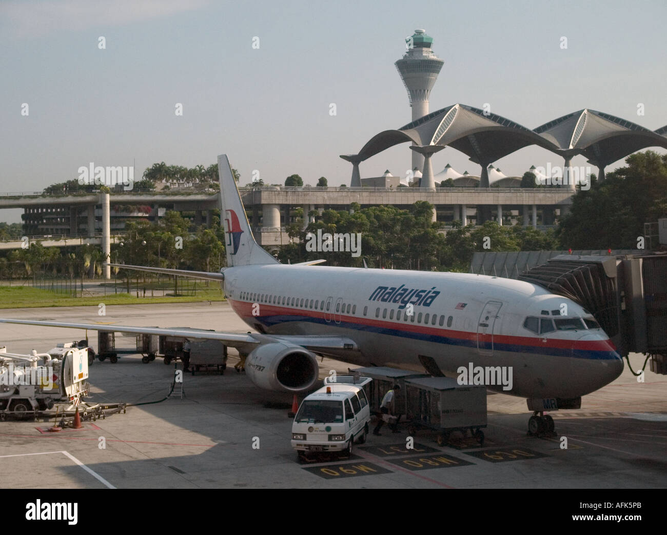 AIR TRAFFIC CONTROL TOWER AND MALAYSIAN AIRLINES PLANE BEING SERVICED ...