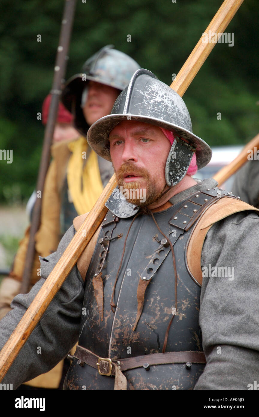 Battle weary soldier carrying a pike at a English civil war reenactment ...